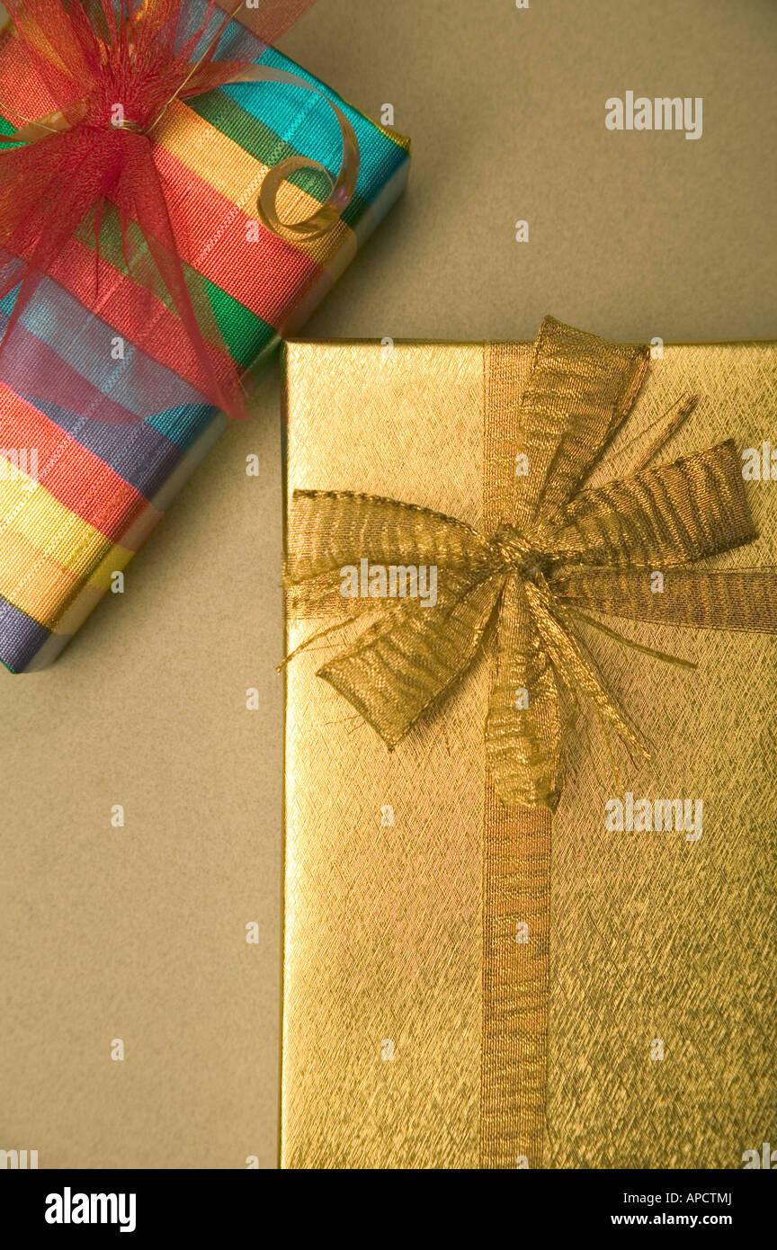 Two wrapped gifts in bright colored paper Stock Photo - Alamy
