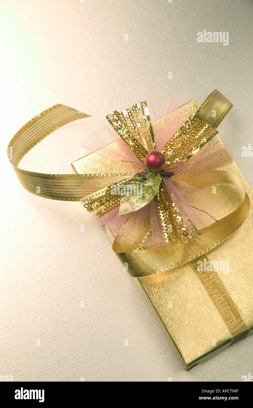 Gold Christmas gift and ribbon Stock Photo - Alamy