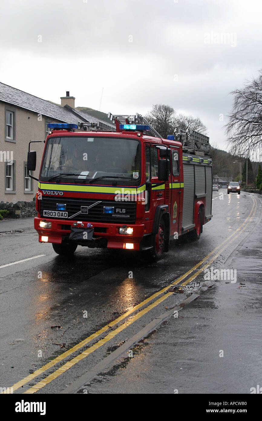 fire engine on a road on a wet winters day going to an emergency call ...