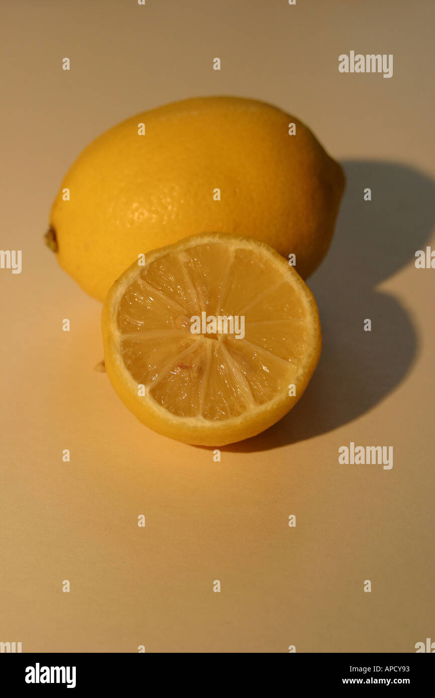 Whole lemon and a cut half lemon Stock Photo - Alamy