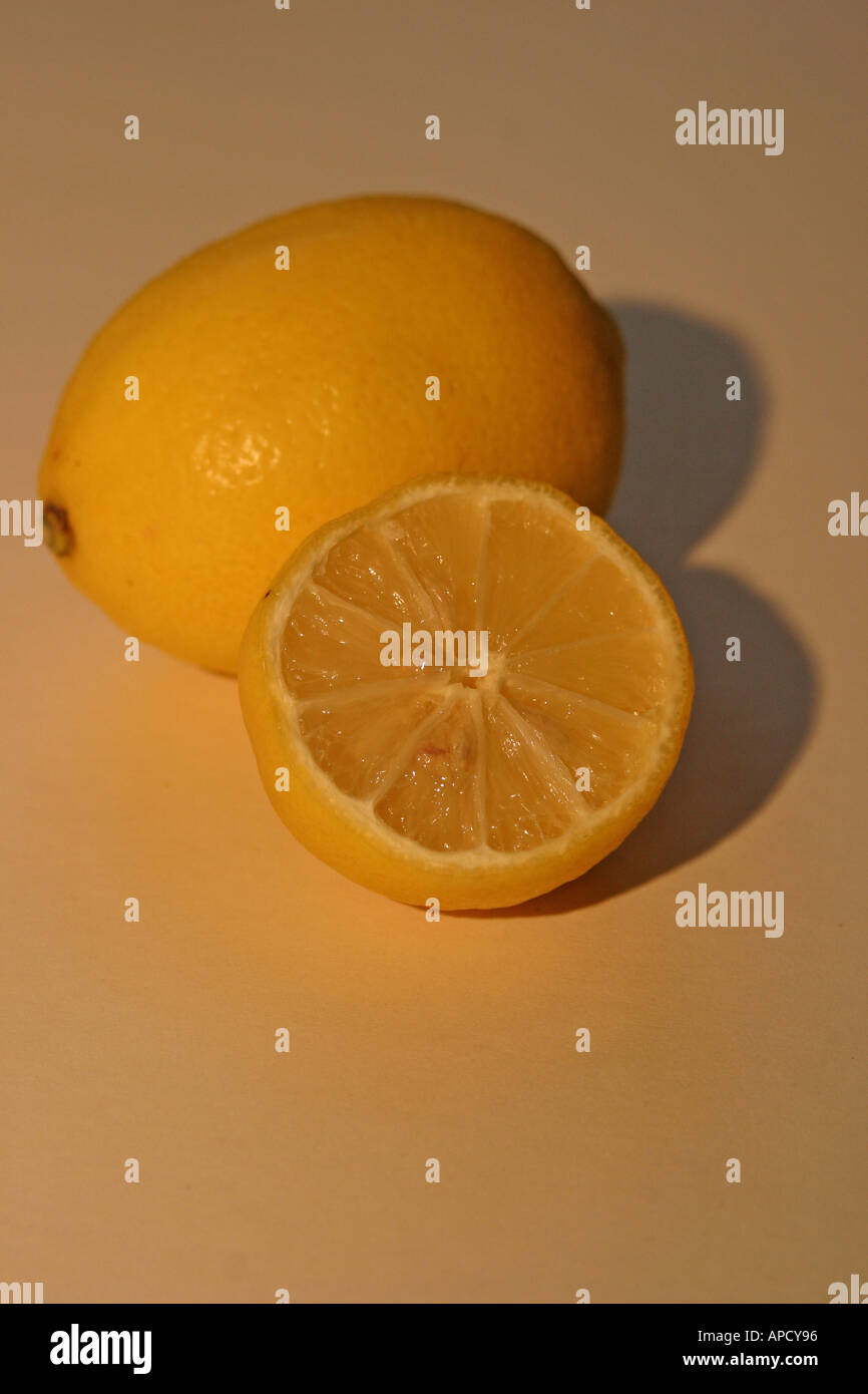 Whole lemon and a cut half lemon Stock Photo - Alamy