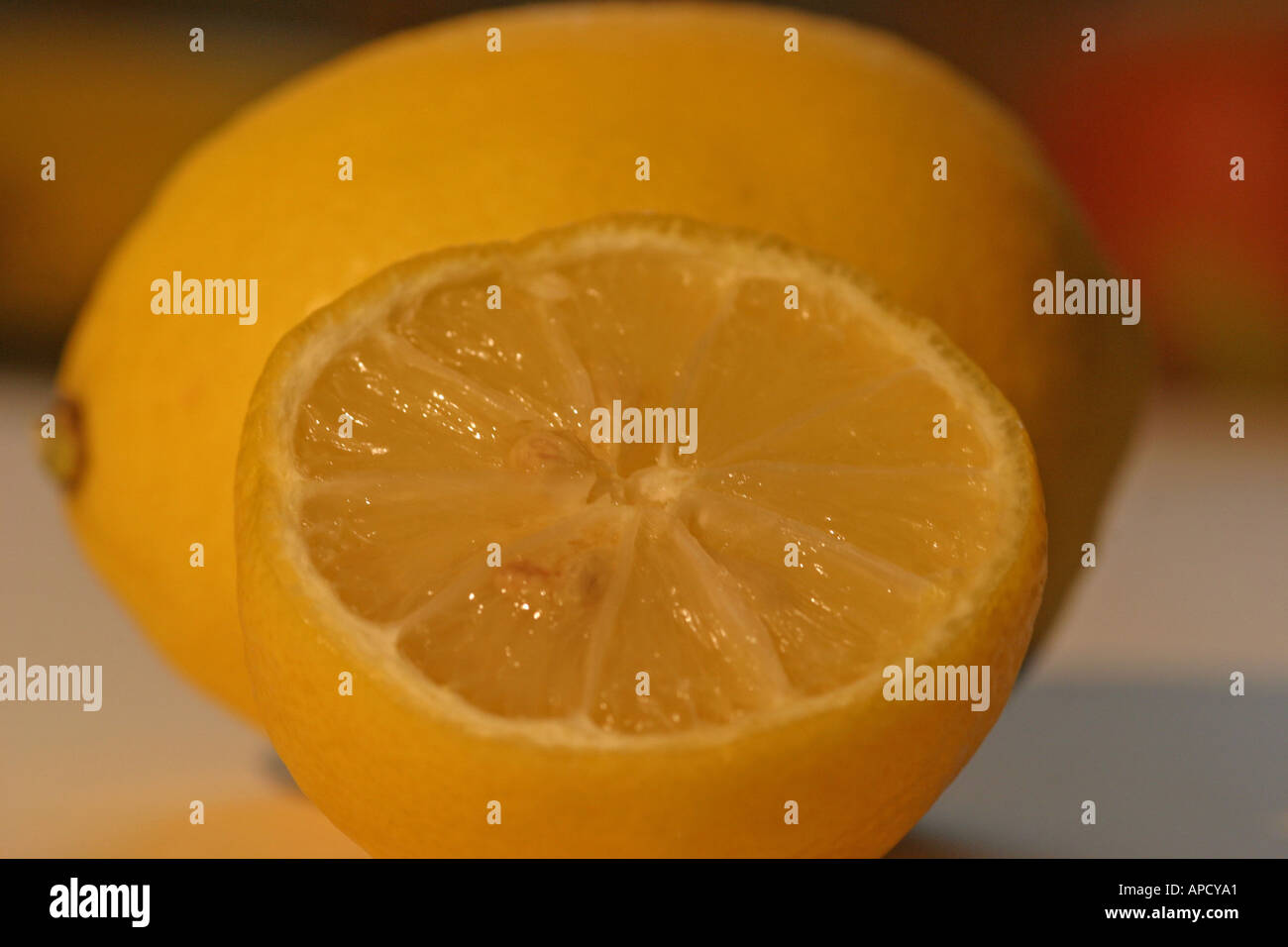 Whole lemon and a cut half lemon Stock Photo - Alamy