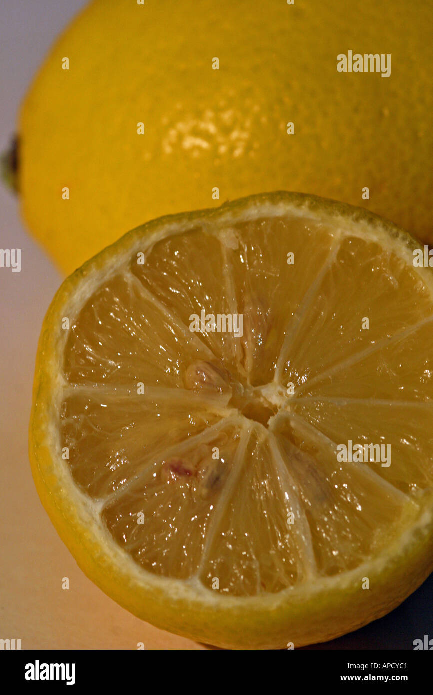Whole lemon and a cut half lemon Stock Photo - Alamy