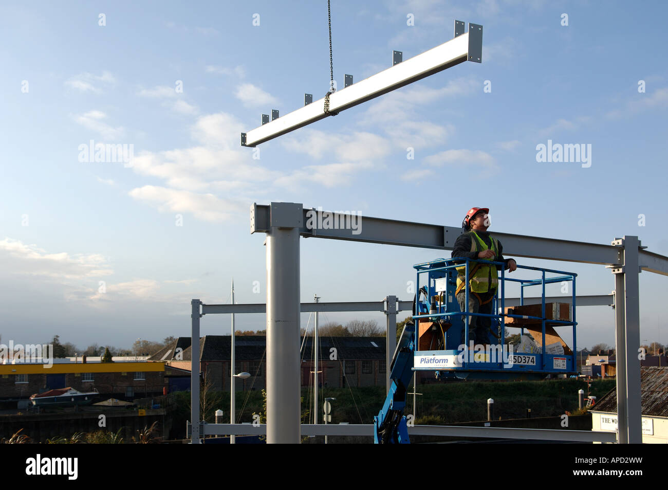 Construction workers lining up steel girder on steel fabricated ...