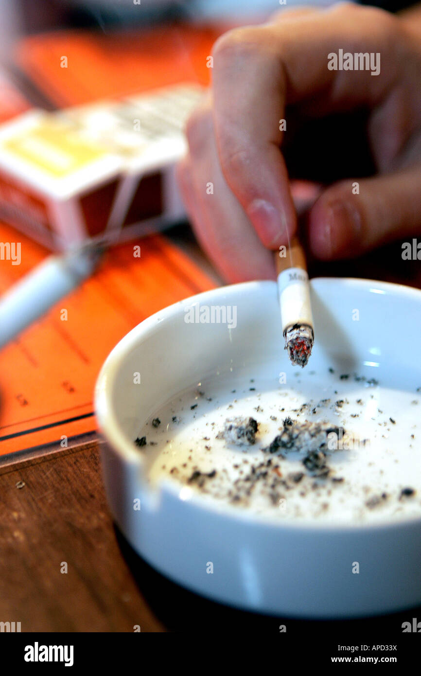 Smoker Using An Ashtray Stock Photo - Alamy