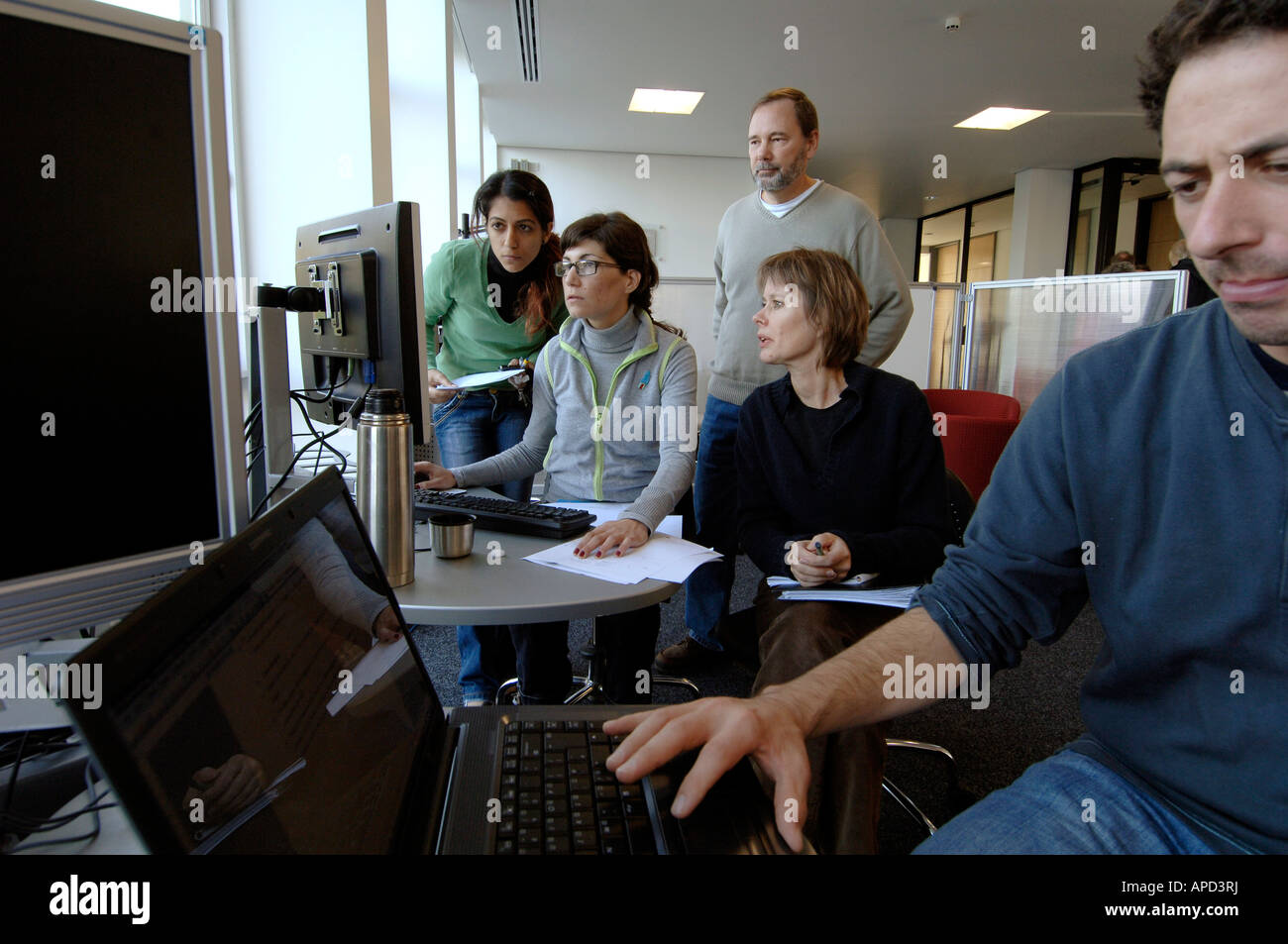 Mature students finishing off a group assignment check their work at ...