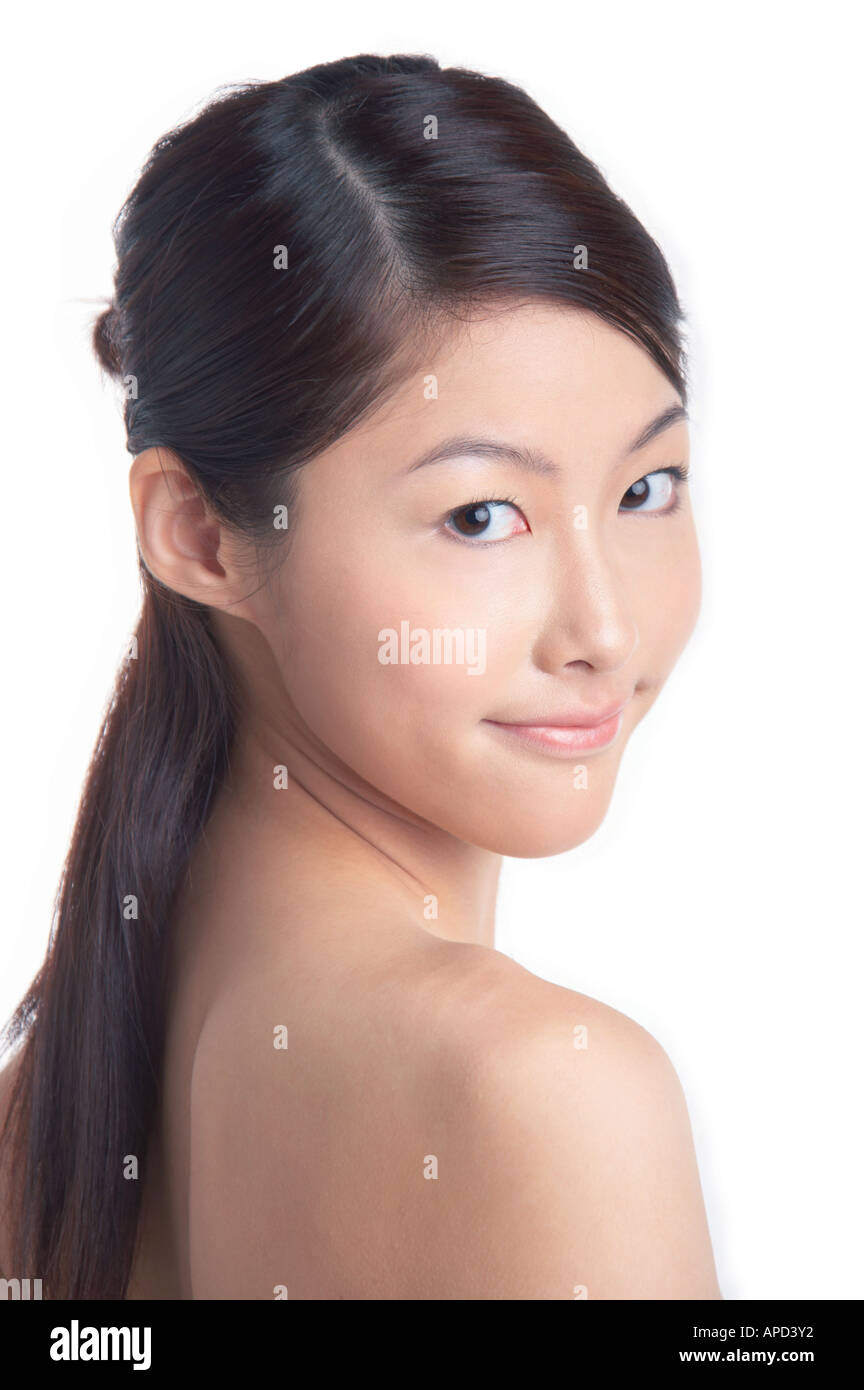 Young woman standing and turning back her head Stock Photo - Alamy