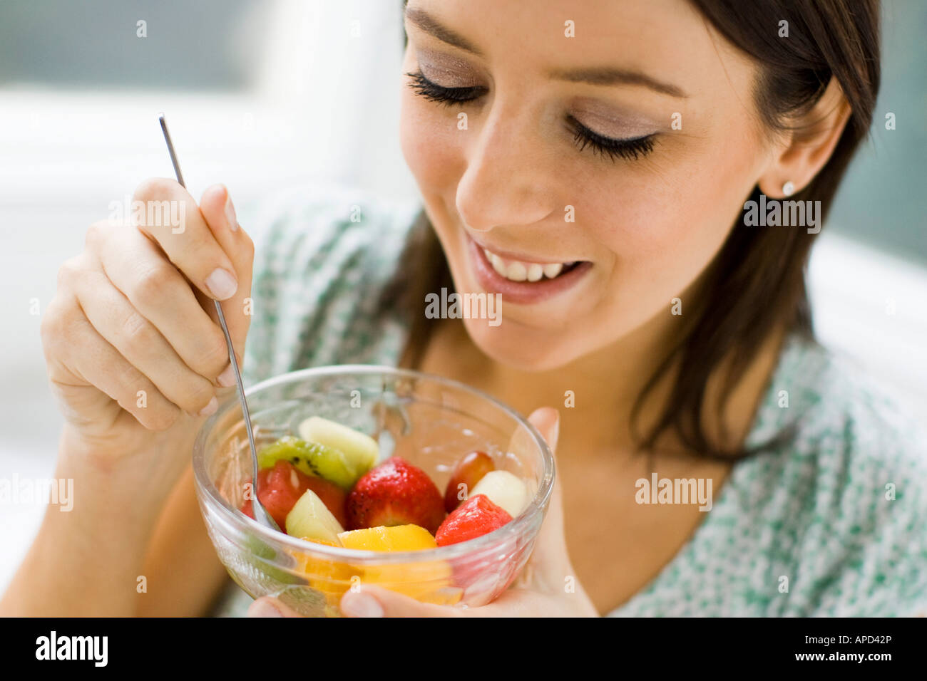 Girl eating fruit Stock Photo - Alamy