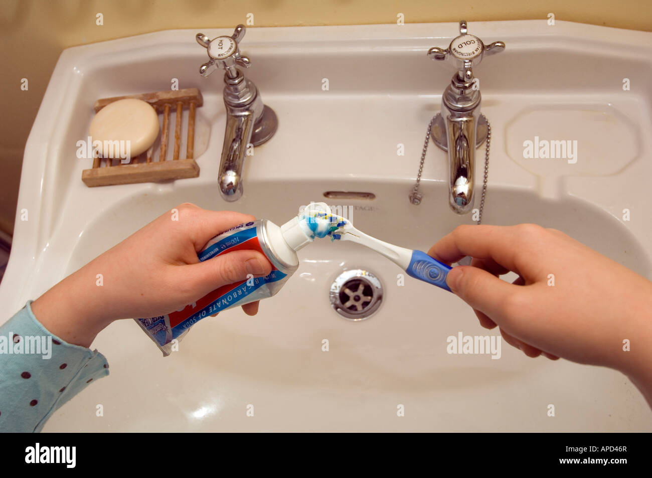 Toothpaste is put on a toothbrush before teeth get a shine Stock Photo ...