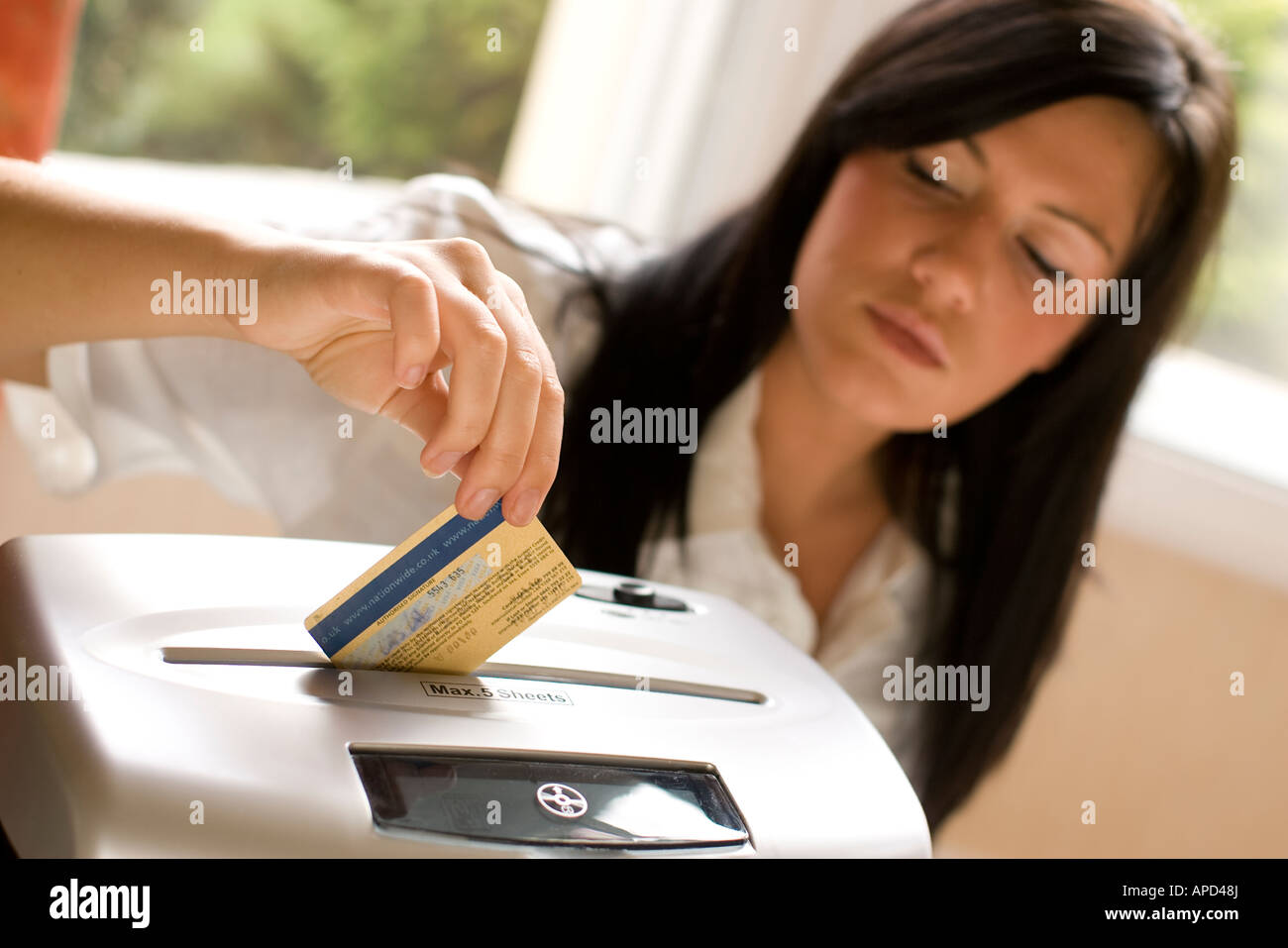 woman shredding credit card Stock Photo - Alamy