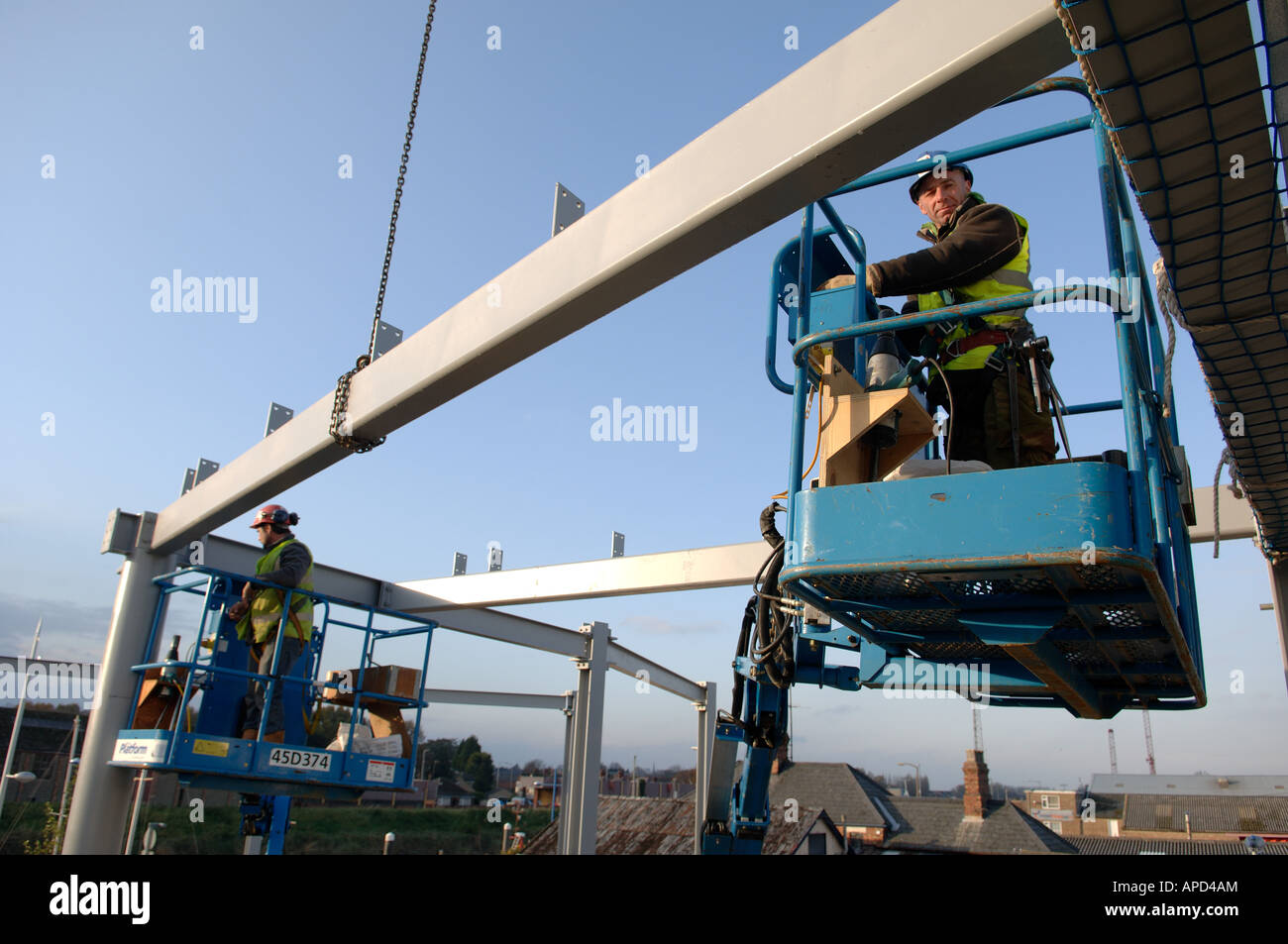 Construction workers lining up steel girder on steel fabricated ...