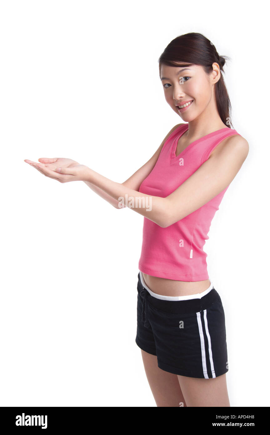 Young woman standing holding somethings side view Stock Photo - Alamy