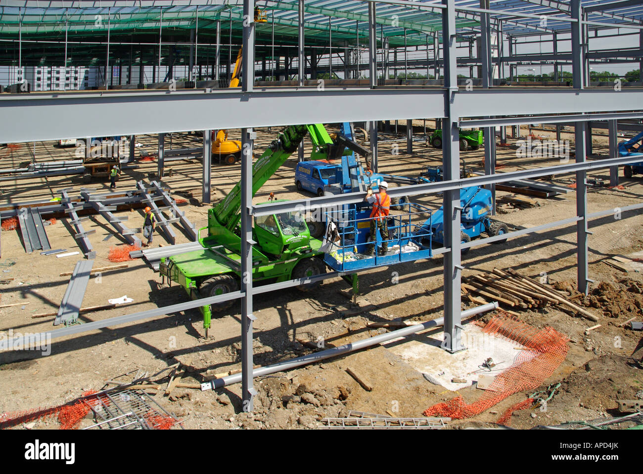 Steel erector on cherry picker access platform during installation of ...