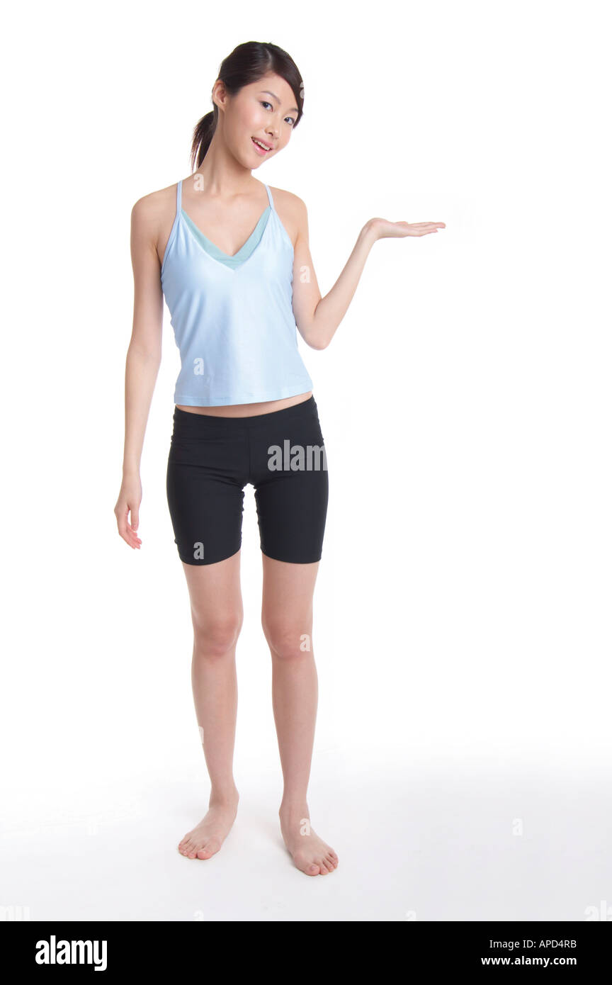 Young woman standing with welcoming pose Stock Photo - Alamy
