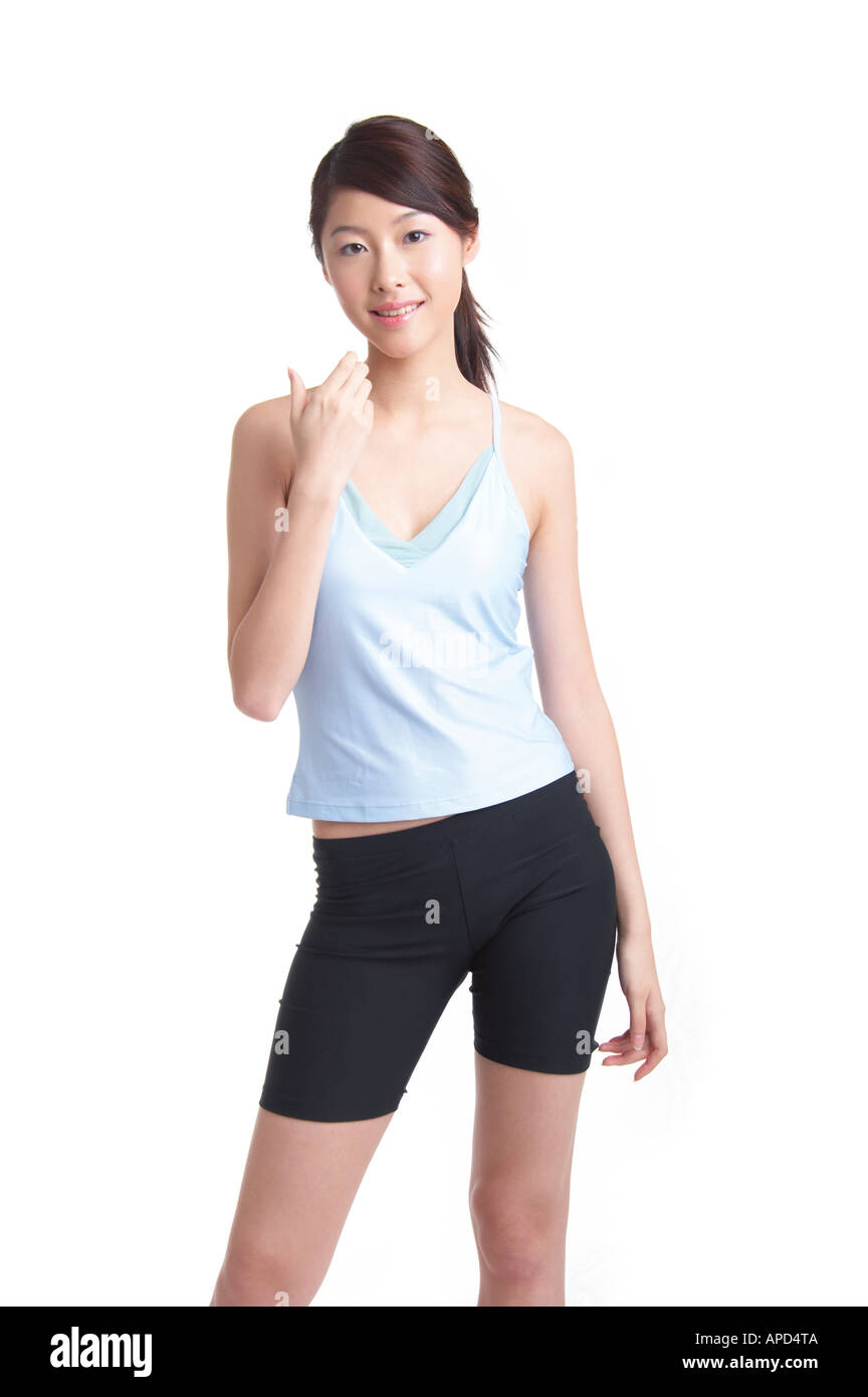 Young woman standing and holding something Stock Photo - Alamy