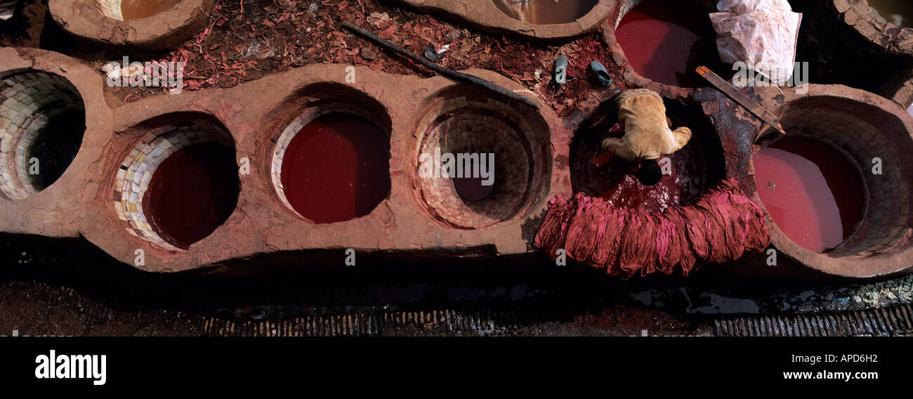 Africa Morocco Worker colors cow hides in ancient die pits at leather ...