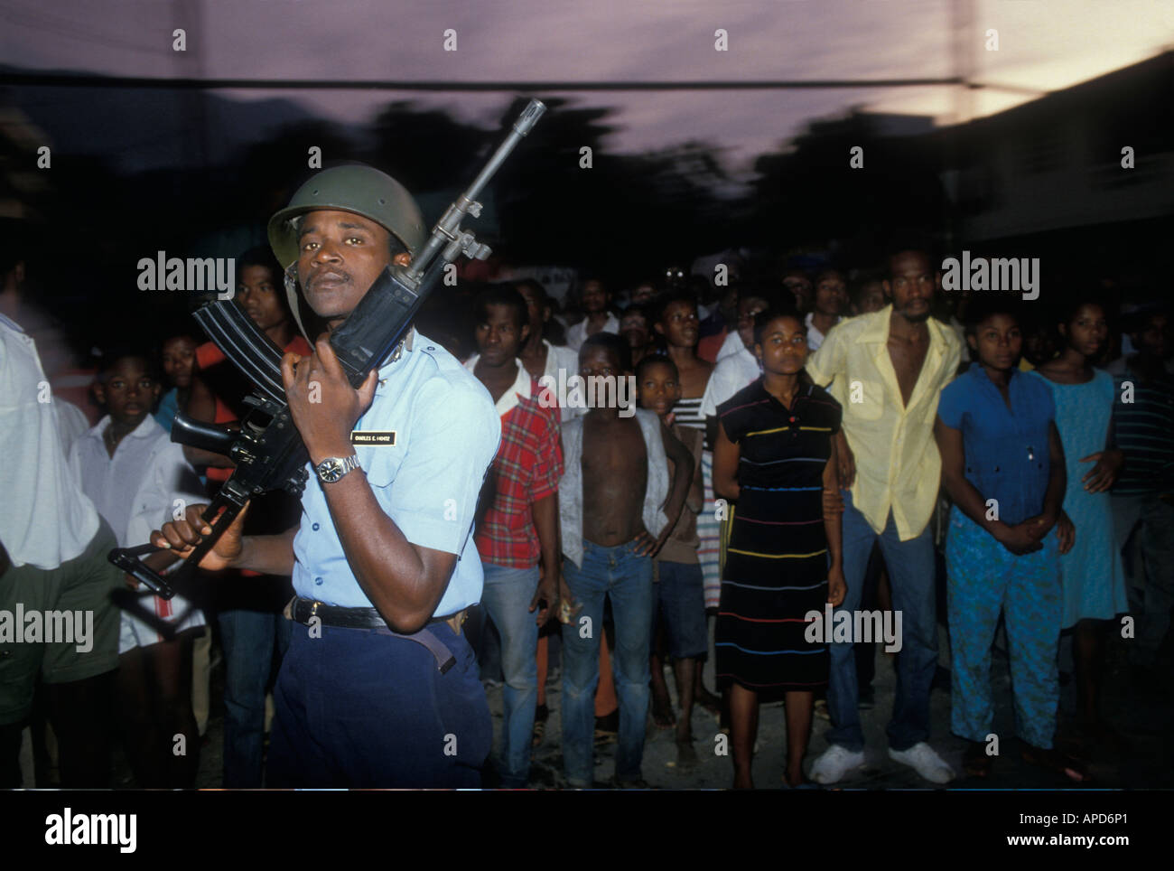 Haiti Port au Prince Army soldier walks past crowd at scene of burning ...