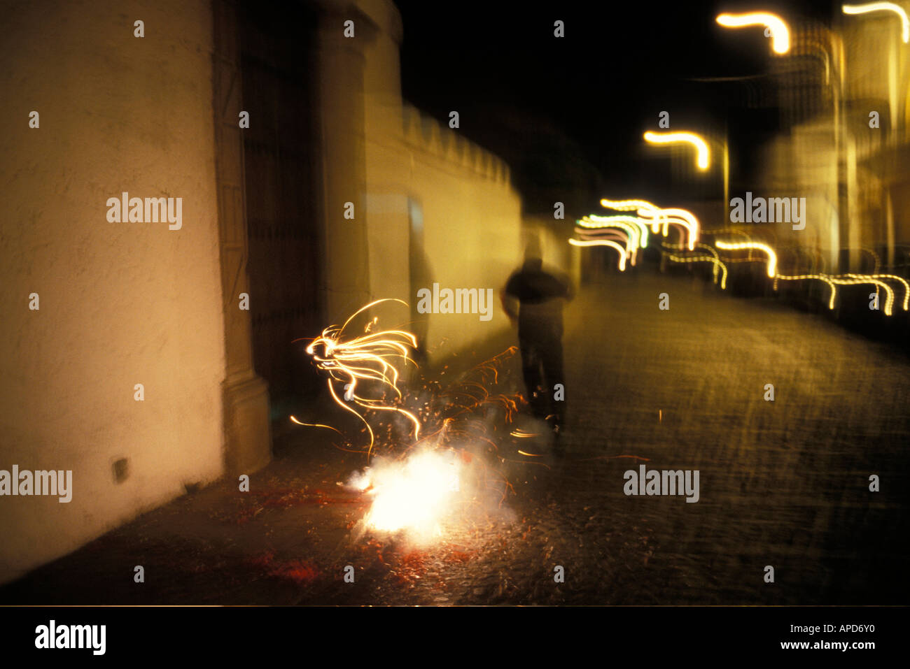 Guatemala Antigua Blurred image of man setting of firecrackers in ...