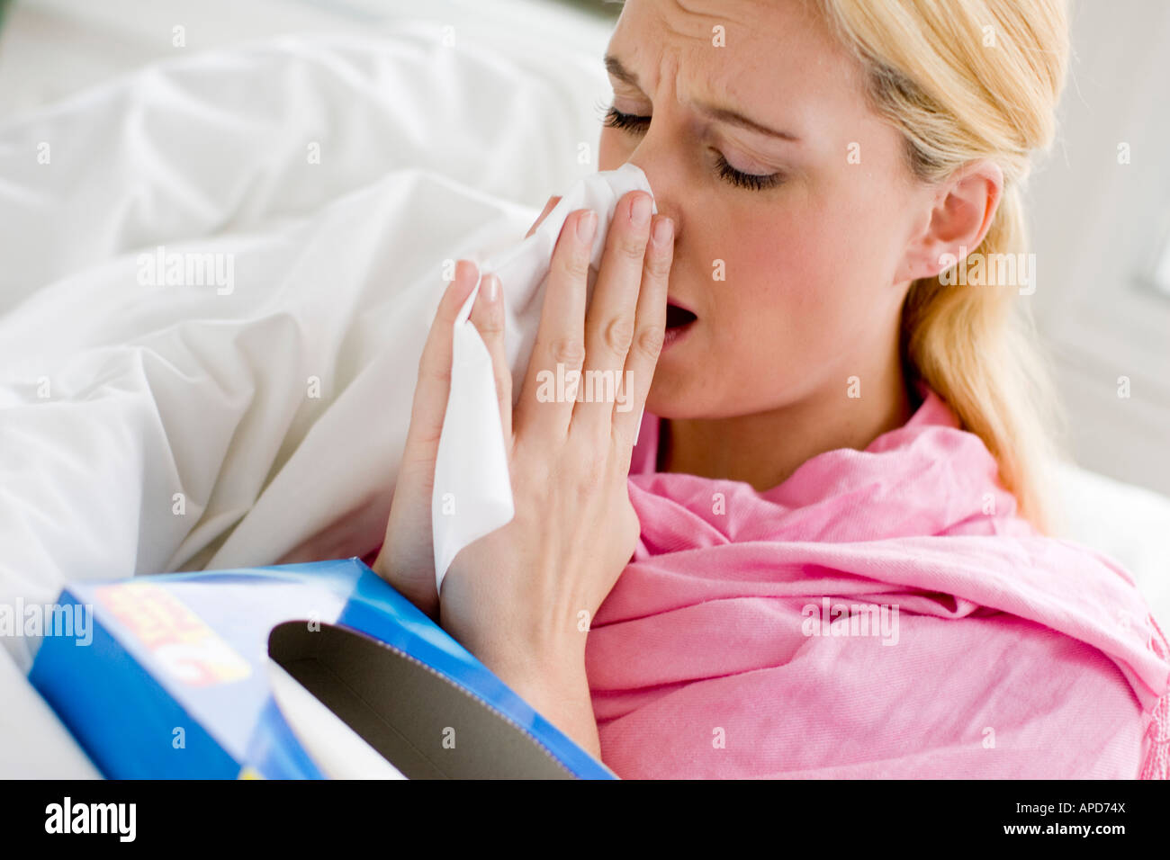 Girl with cold blowing nose Stock Photo - Alamy
