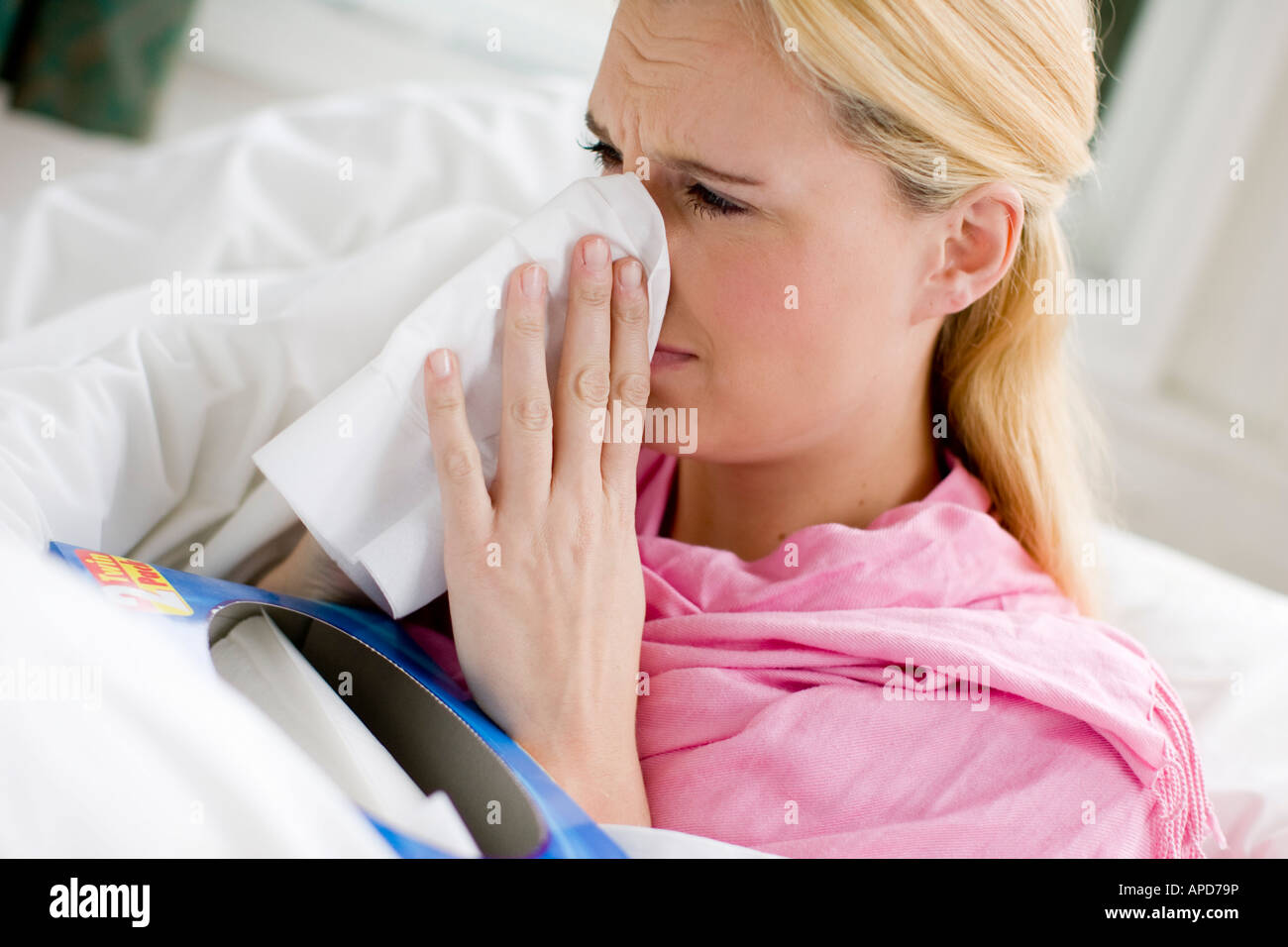 Girl with cold blowing nose Stock Photo - Alamy