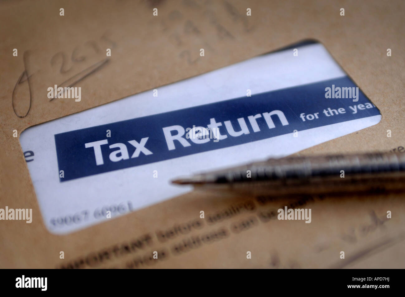 A tax return form viewed throught the window of a brown envelope Stock ...