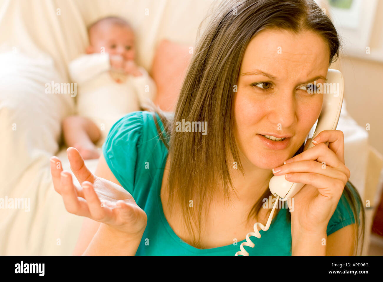 Mother phoning doctor about ill baby Stock Photo - Alamy