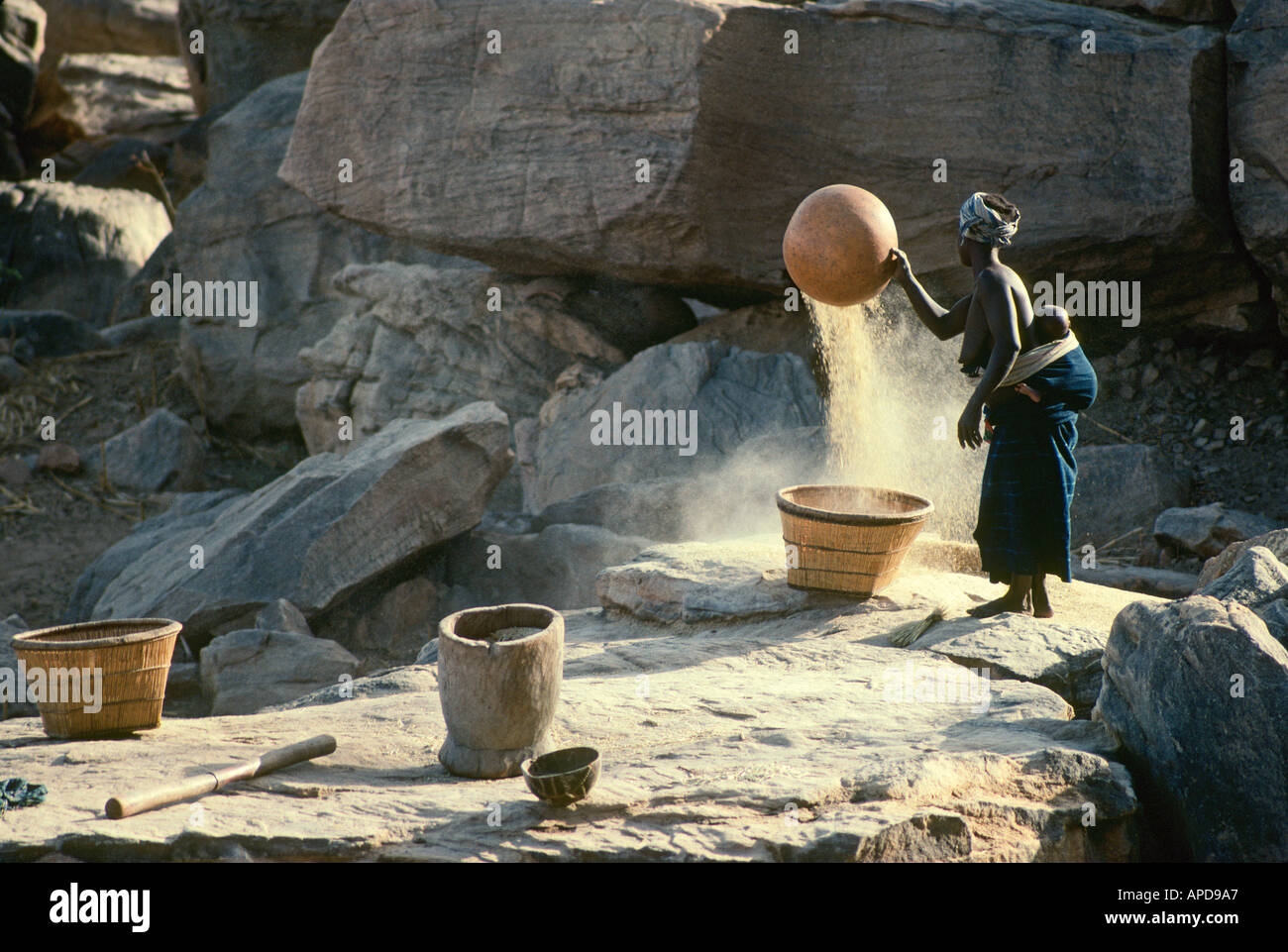 African woman winnowing millet hi-res stock photography and images - Alamy