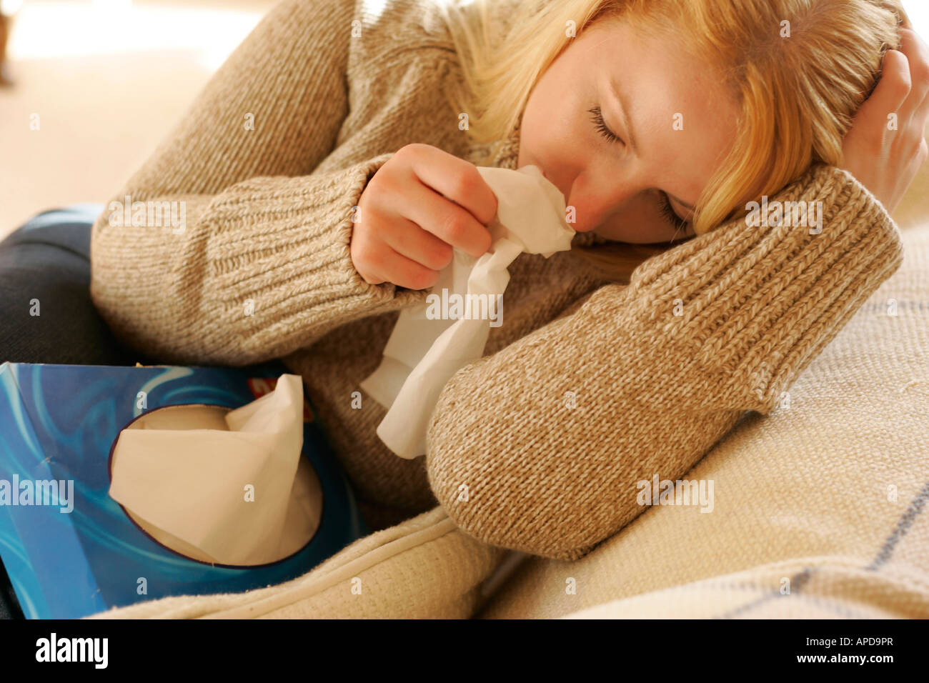 woman with cold and box of tissues Stock Photo - Alamy