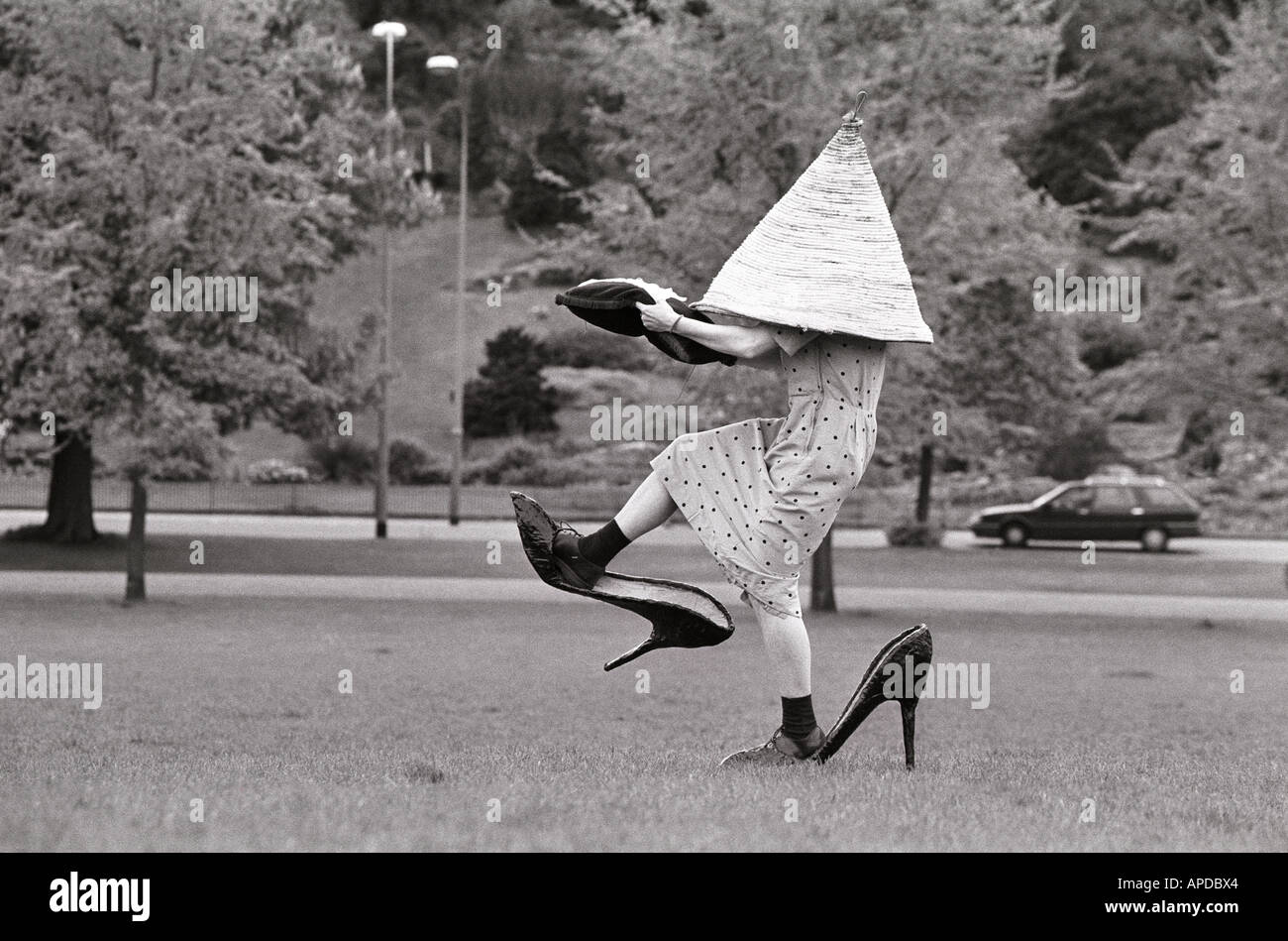 Actress larking about on the grass with the props for an alternative ...