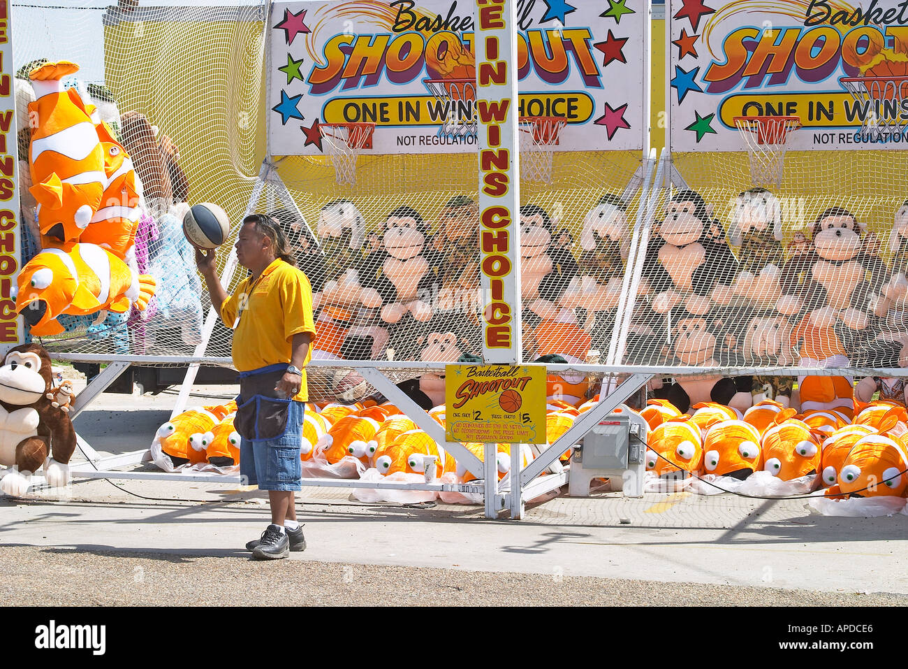 Carnival worker holding a basketball waiting for customers Stock Photo ...