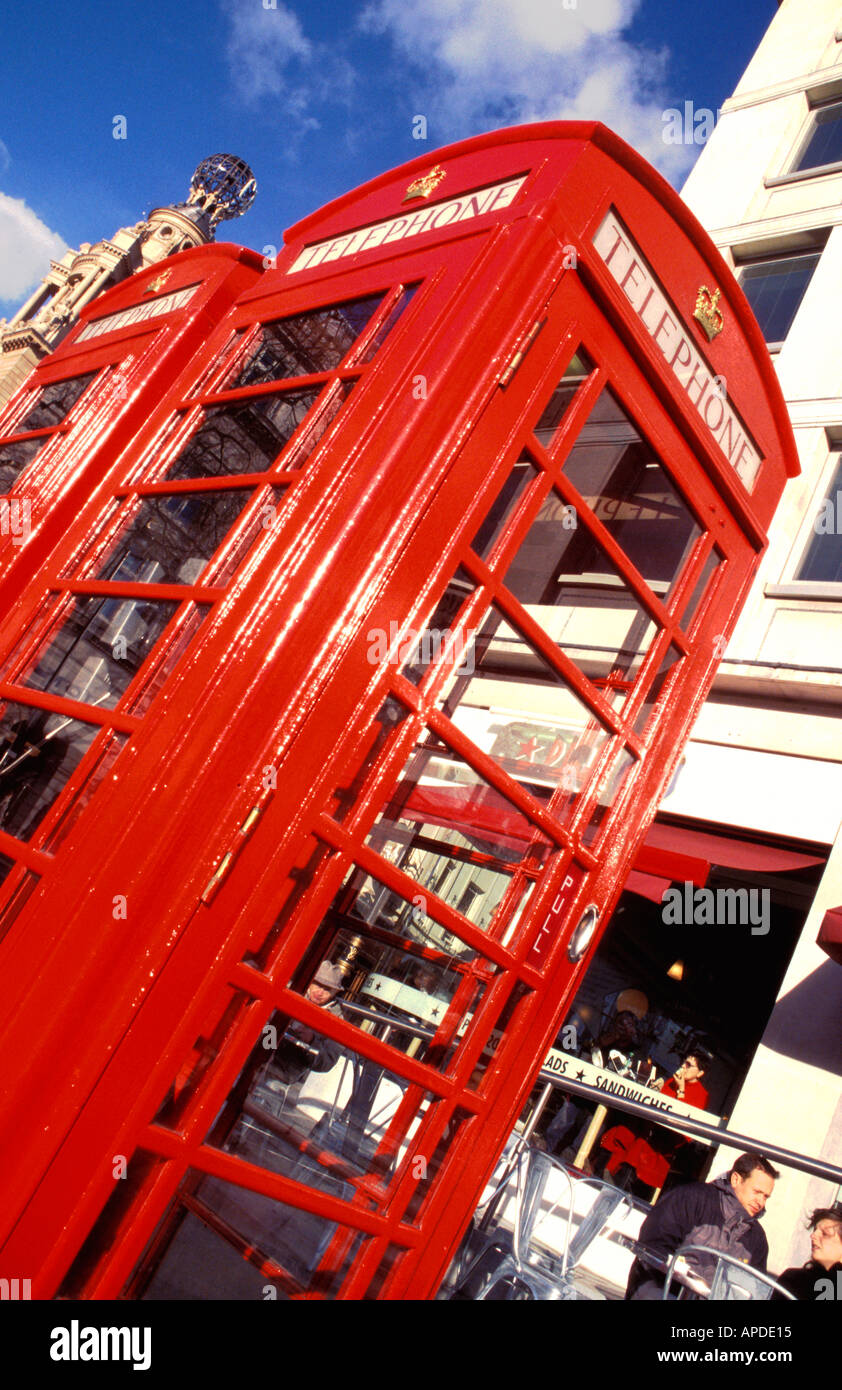 Traditional red telephone boxes outside the London Coliseum opera house ...