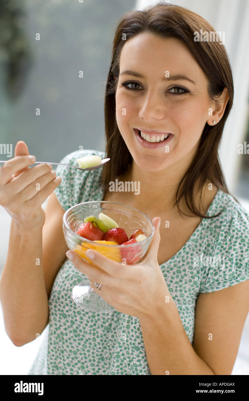 Girl eating fruit Stock Photo - Alamy