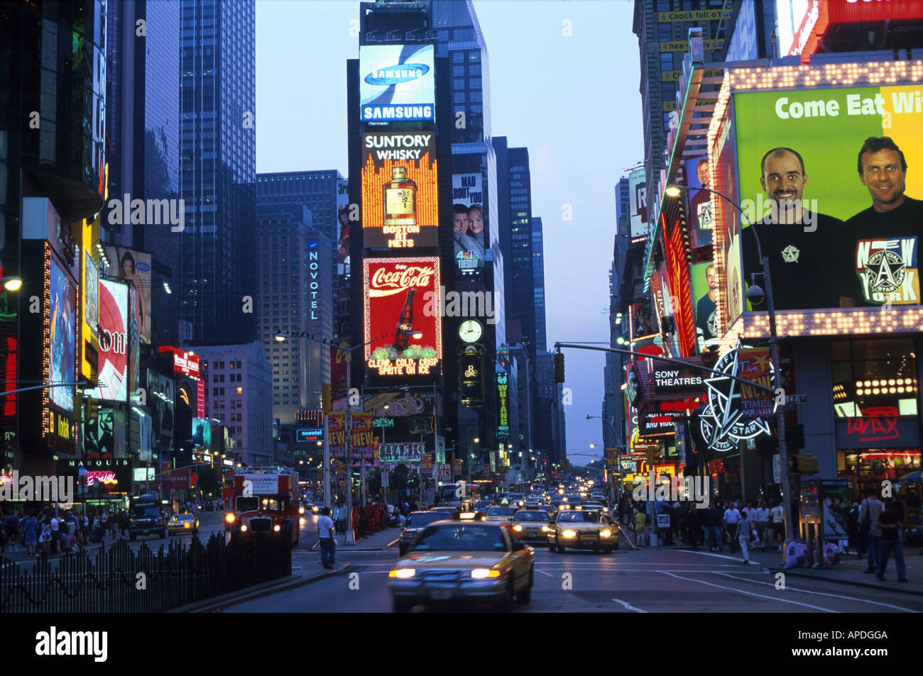 High rise buildings with neon signs and cars on the Times Square ...