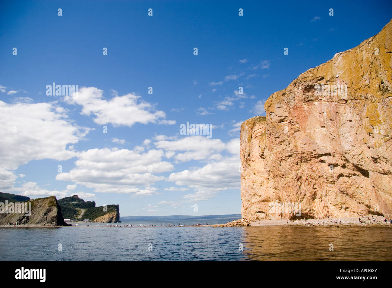Tourists crowd around at low tide on Perce Rock on a summer day Stock ...