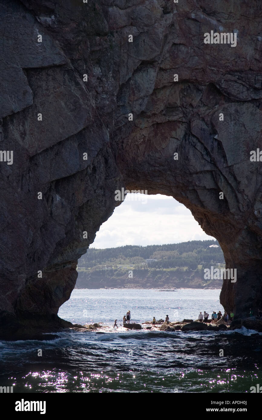Tourists crowd the hole in Perce Rock at low tide Stock Photo - Alamy