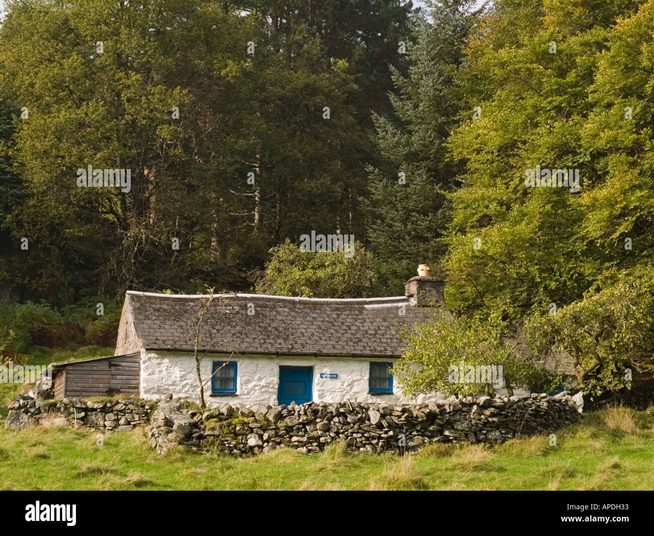 ISOLATED OLD STONE COTTAGE with slate roof and white ^washed walls ...
