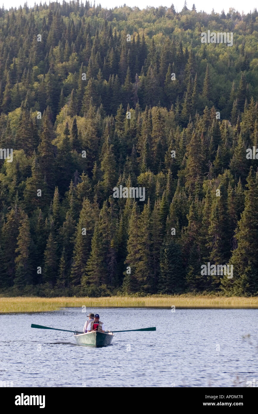 A couple row across a mountain lake Stock Photo - Alamy