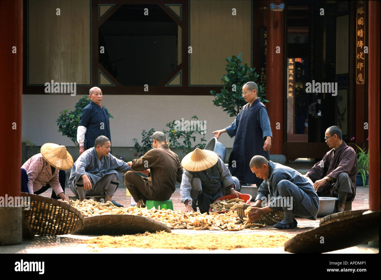 Monks and nuns with harvest at the inner courtyard of a monastery ...