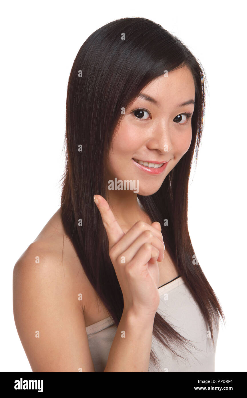 Young woman with long hair smiling raising index finger Stock Photo - Alamy