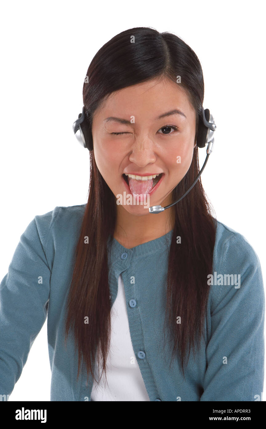 Young woman wearing headphone closing one eye and making a face Stock ...