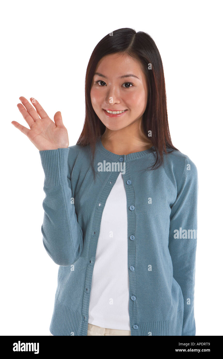 Young woman standing hand raised Stock Photo - Alamy