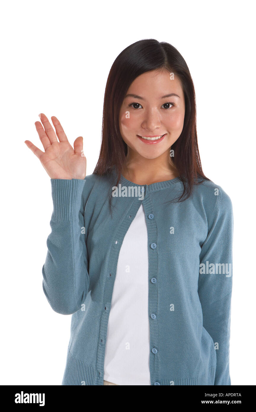 Young woman standing hand raised Stock Photo - Alamy