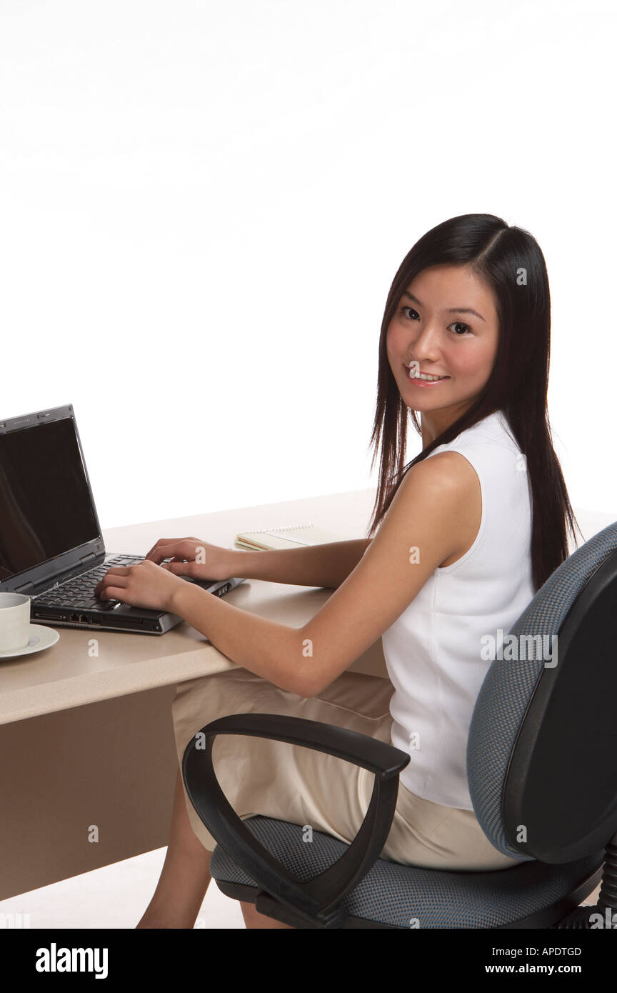 Young woman working looking back in office environment Stock Photo - Alamy