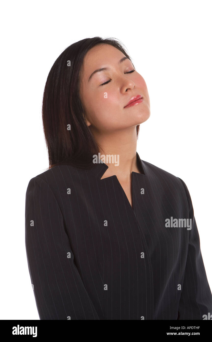 Young woman in business suit raising head and relaxing Stock Photo - Alamy