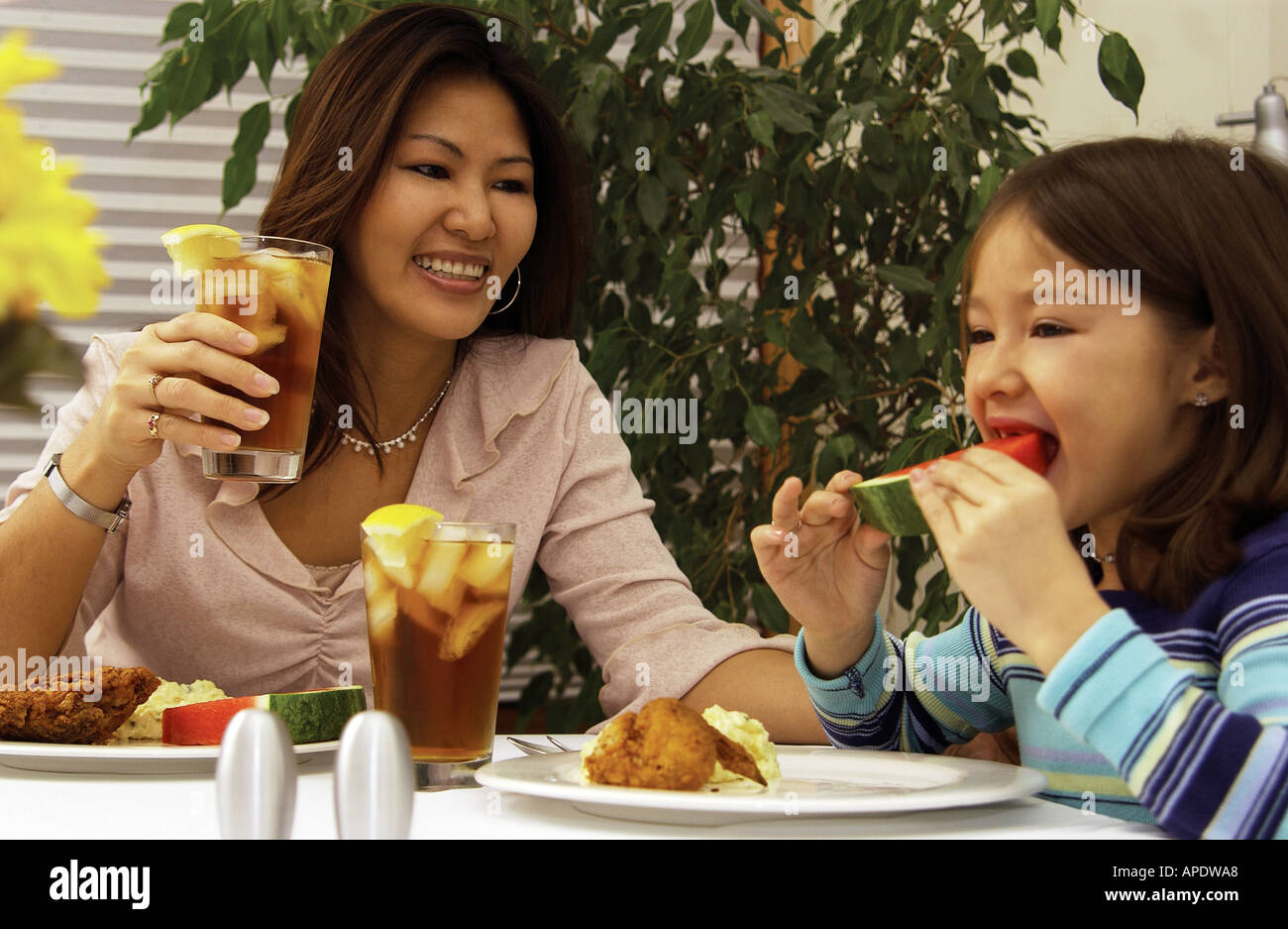 Asian mom and daughter eating Stock Photo - Alamy
