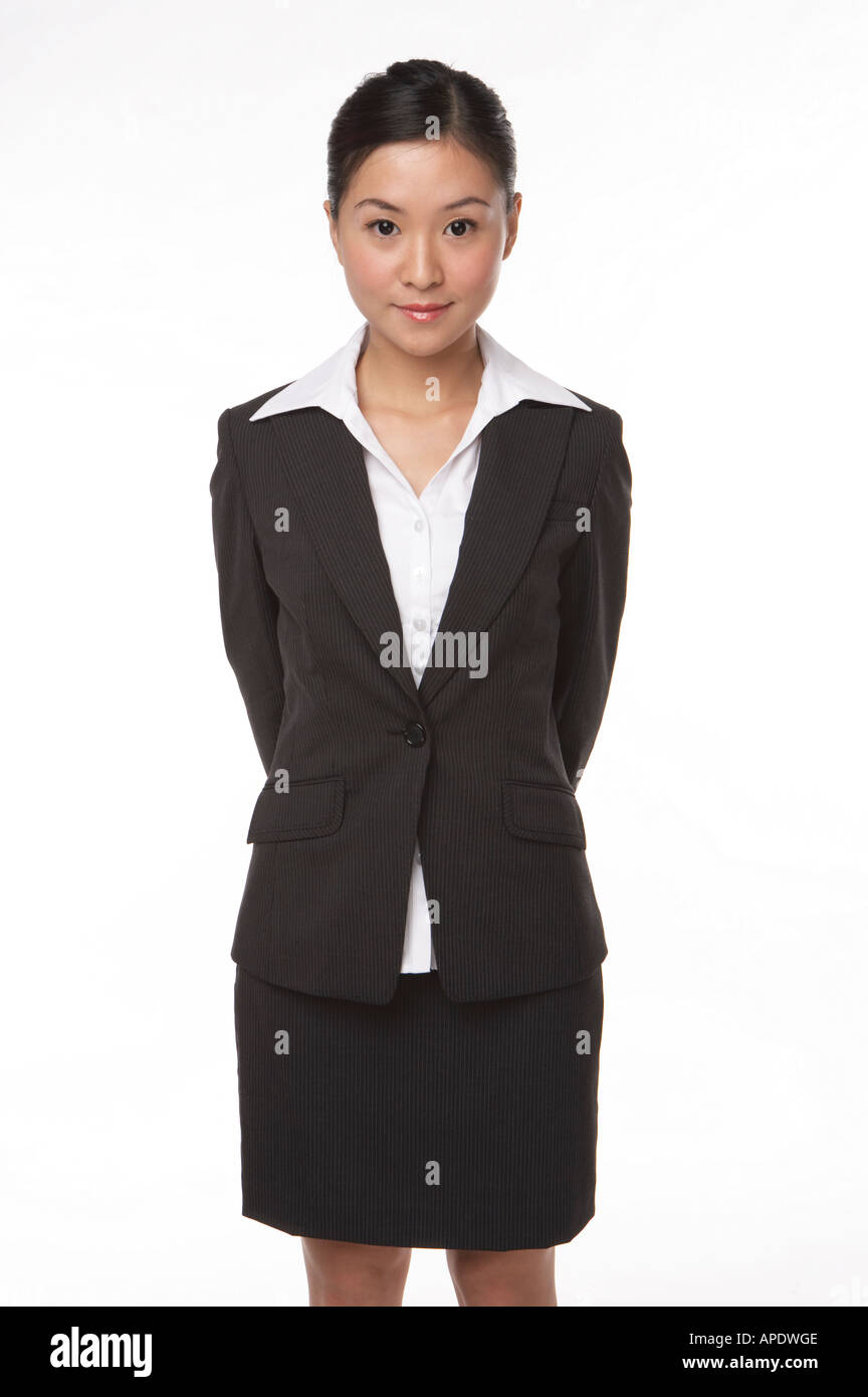 Young woman in business suit standing formally Stock Photo - Alamy