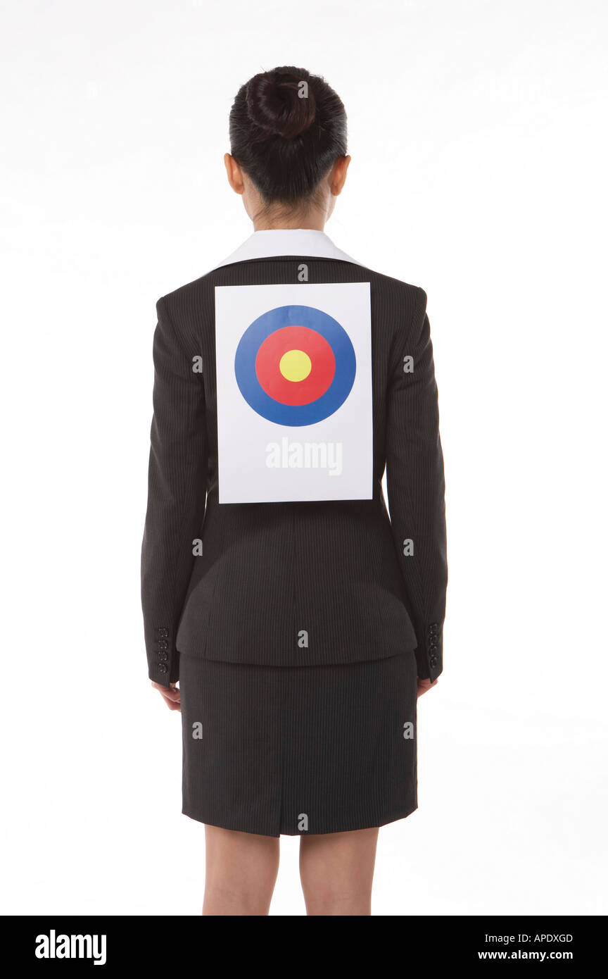 Young woman in business suit standing wearing a target on back rear ...