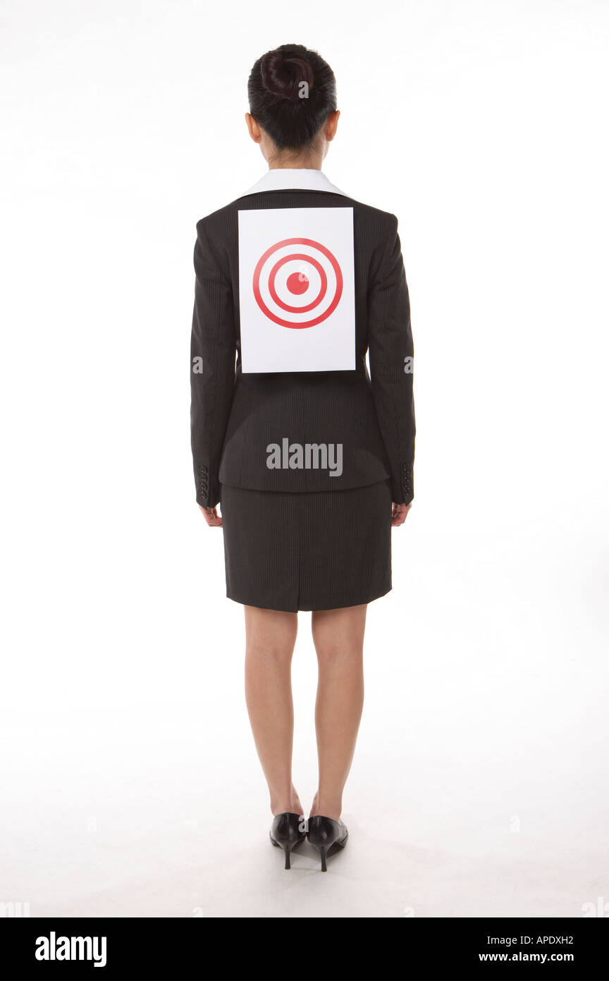 Young woman in business suit standing wearing a target on back rear ...