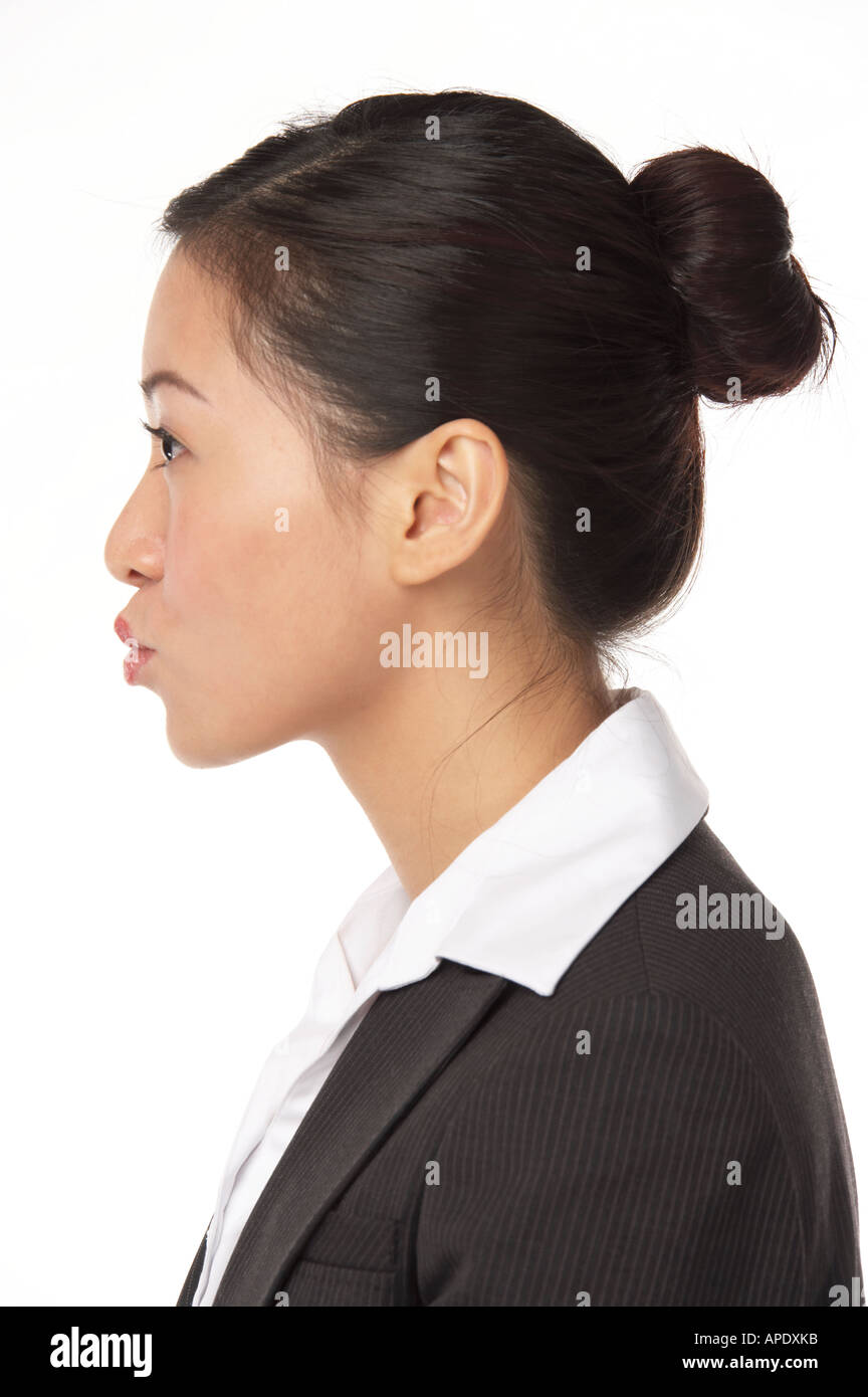 Young woman in business suit pouting lips close up side view Stock ...