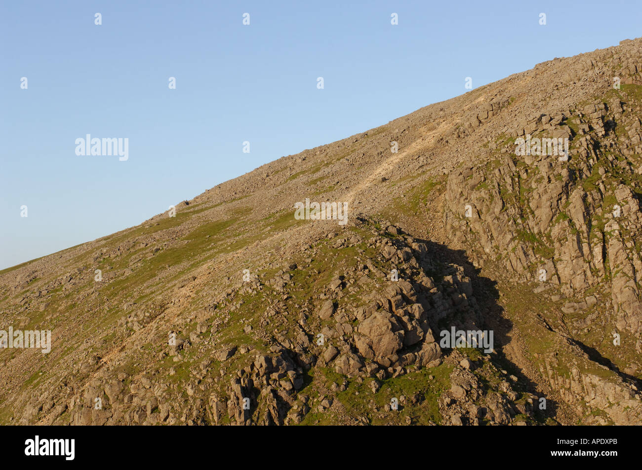 The rock strewn hillside of Great Gable in under a blue sky the English ...